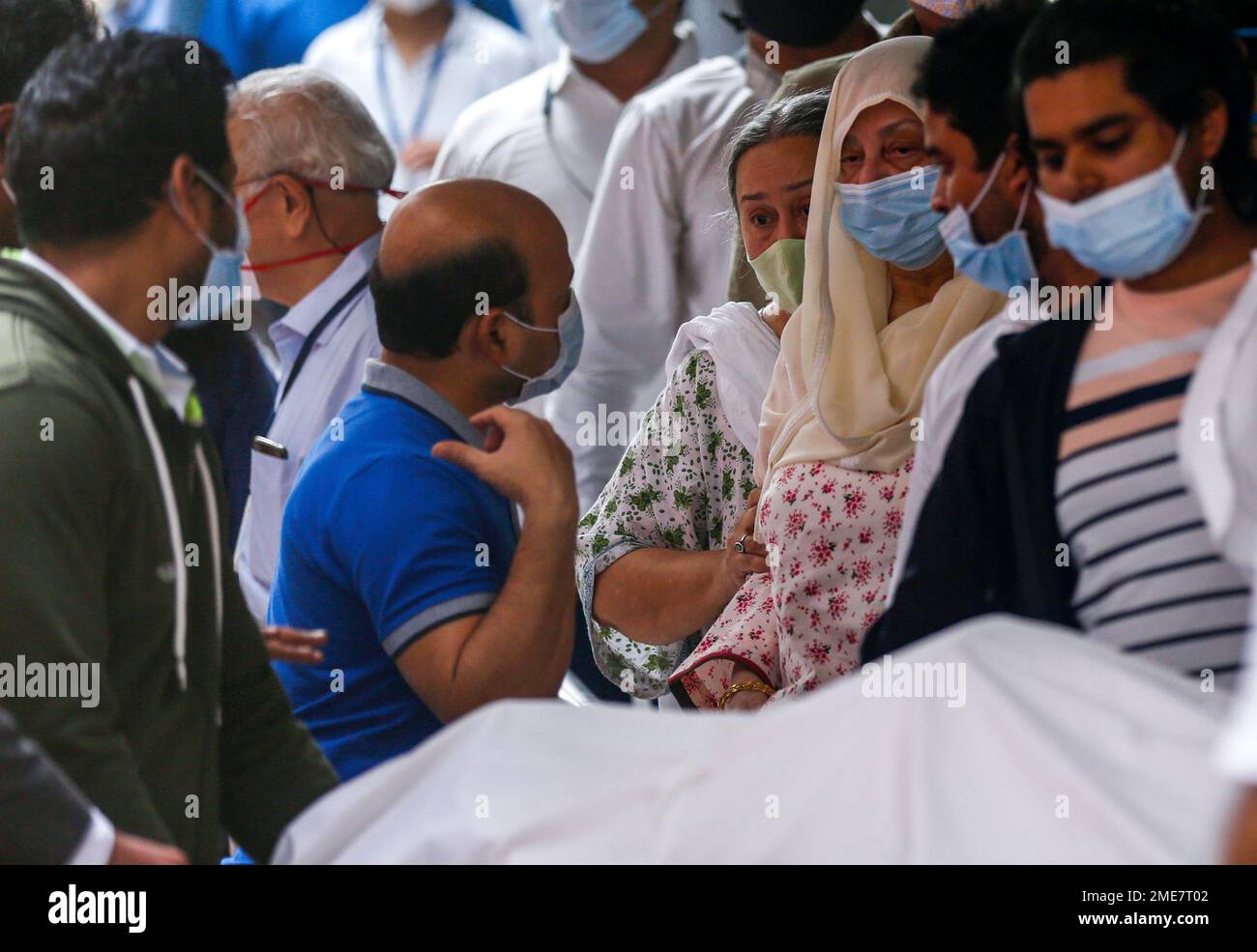 Saira Banu, wife of Indian actor Dilip Kumar, wearing blue mask, center ...