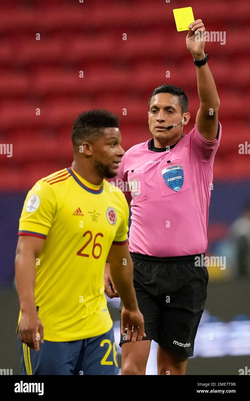 Jesus Valenzuela, of Venezuela, show the yellow card to Colombia's ...