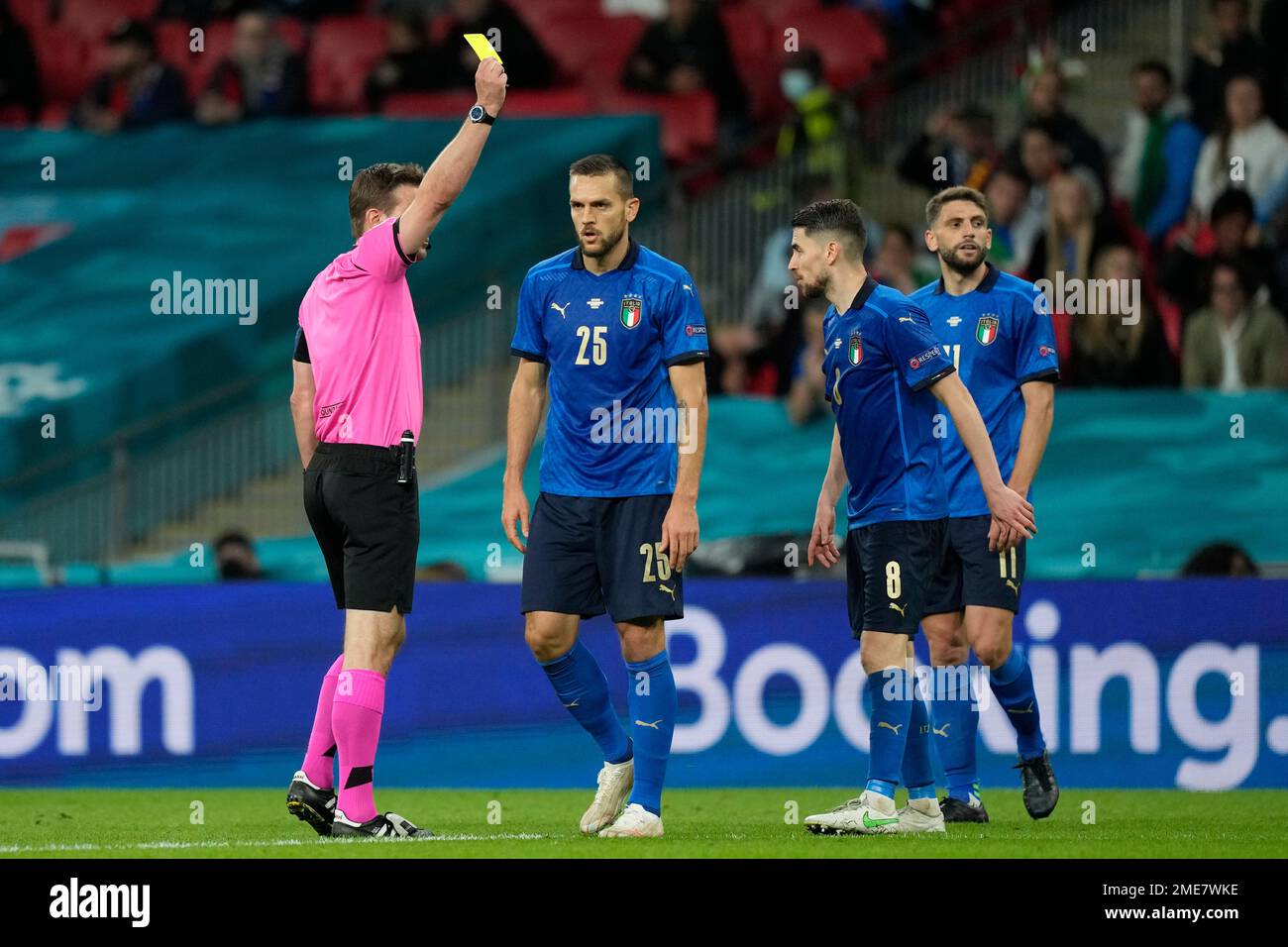 German referee Felix Brych, left, shows a yellow card to Italy's Rafael ...