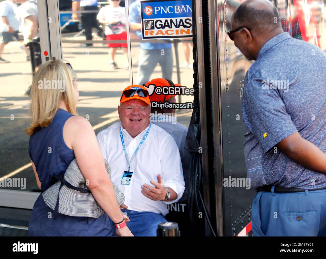 Car owner Chip Ganassi talks with fans Kristin Emery and Craig Saunders ...