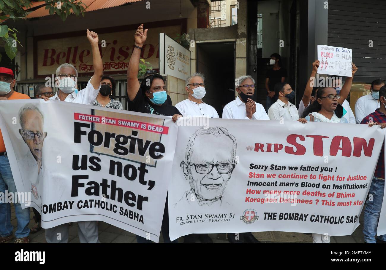 People hold banners and shout slogans during a prayer meeting for ...
