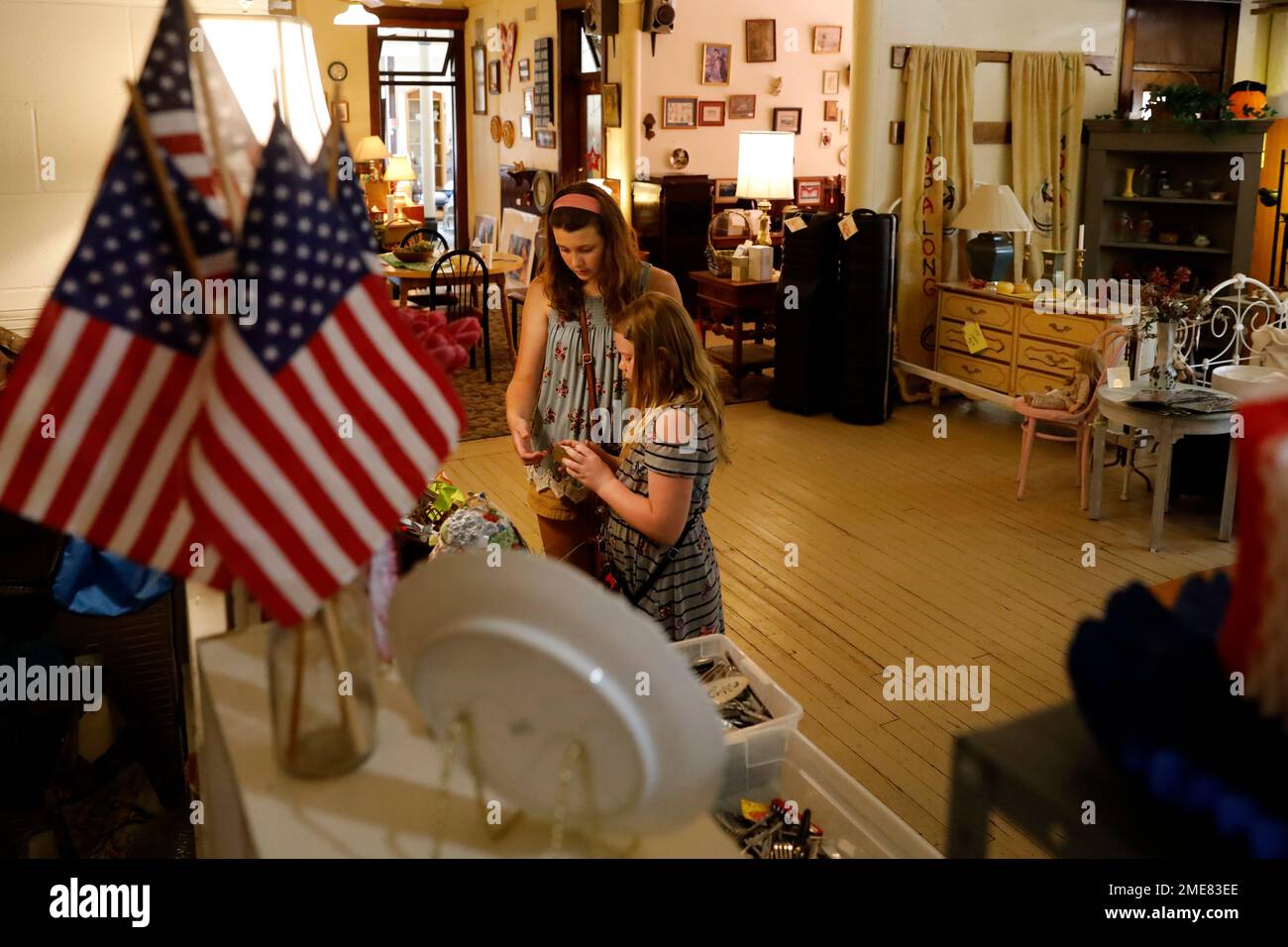 Lena Anderson left, and her sister Cora, look at merchandise at the ...