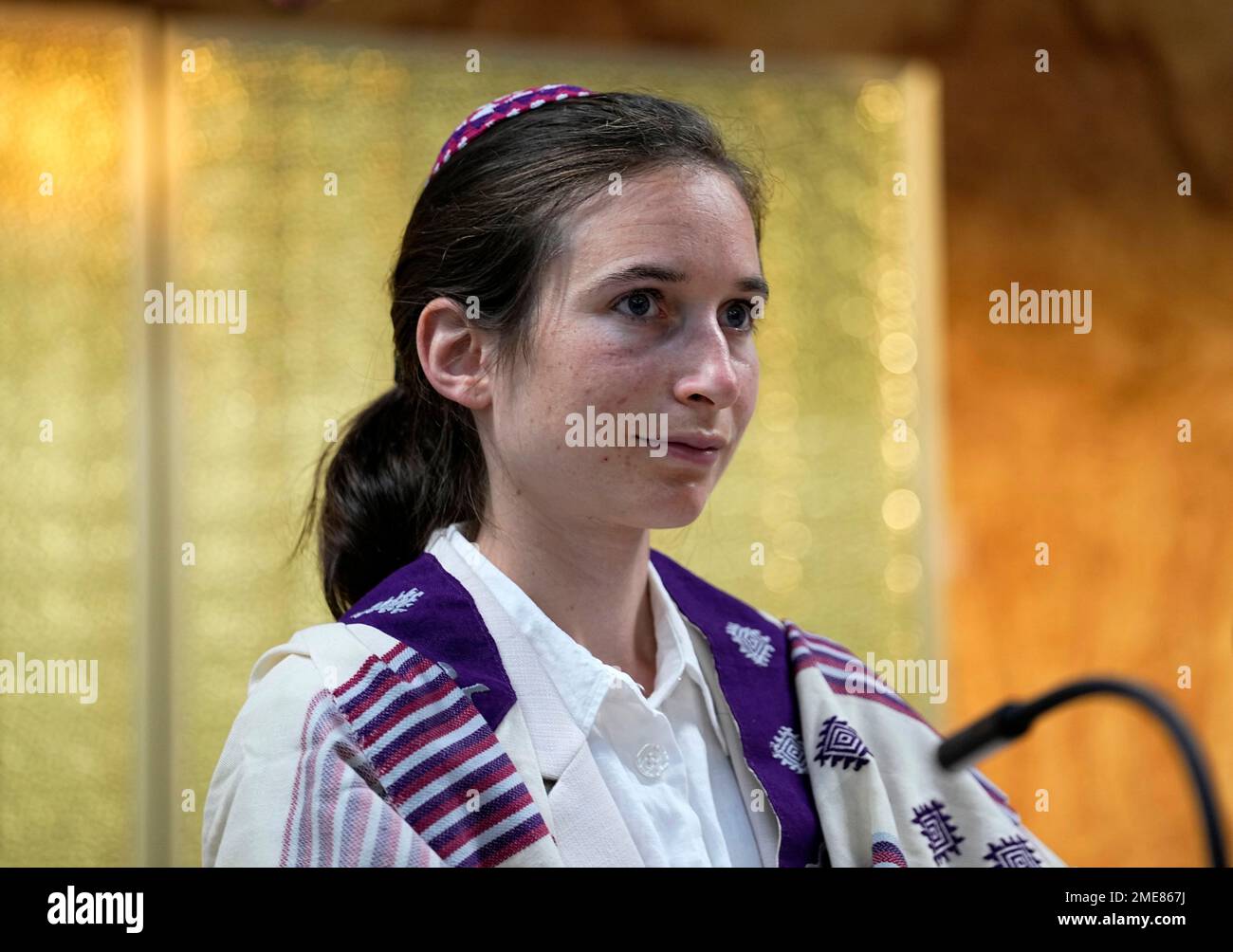 French Iris Ferreira wears a prayer shawl as she attends a ceremony to ...