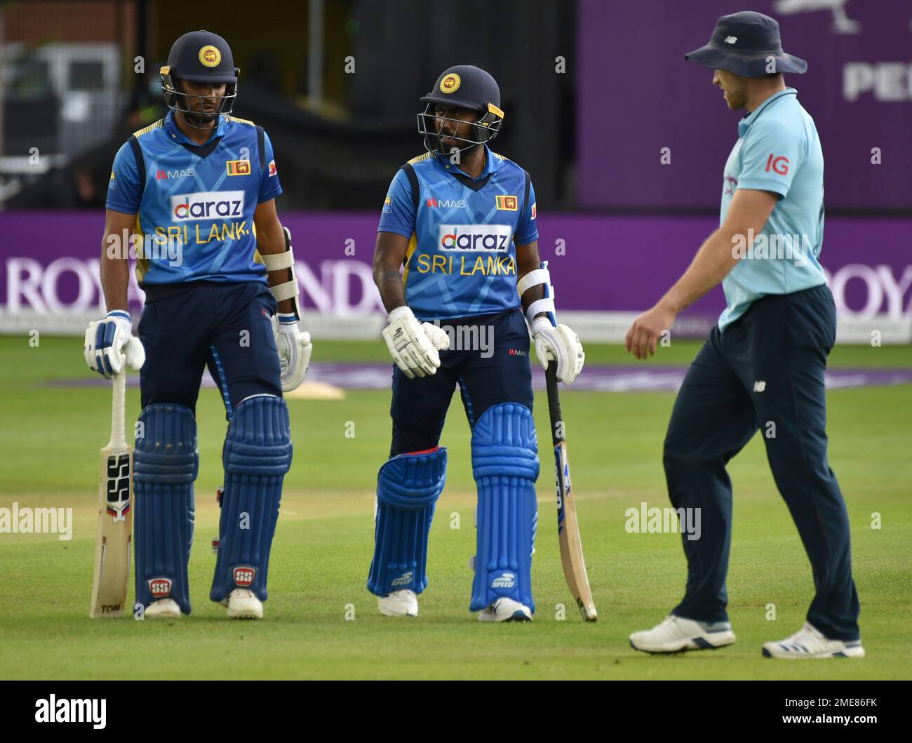 Sri Lanka's Dasun Shanaka, left, leaves the field with batting partner ...