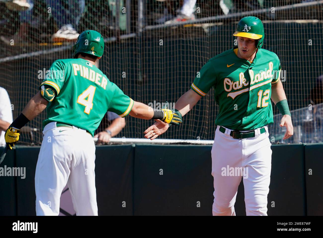 Oakland Athletics' Sean Murphy (12) is congratulated by Chad Pinder after scoring against the ...