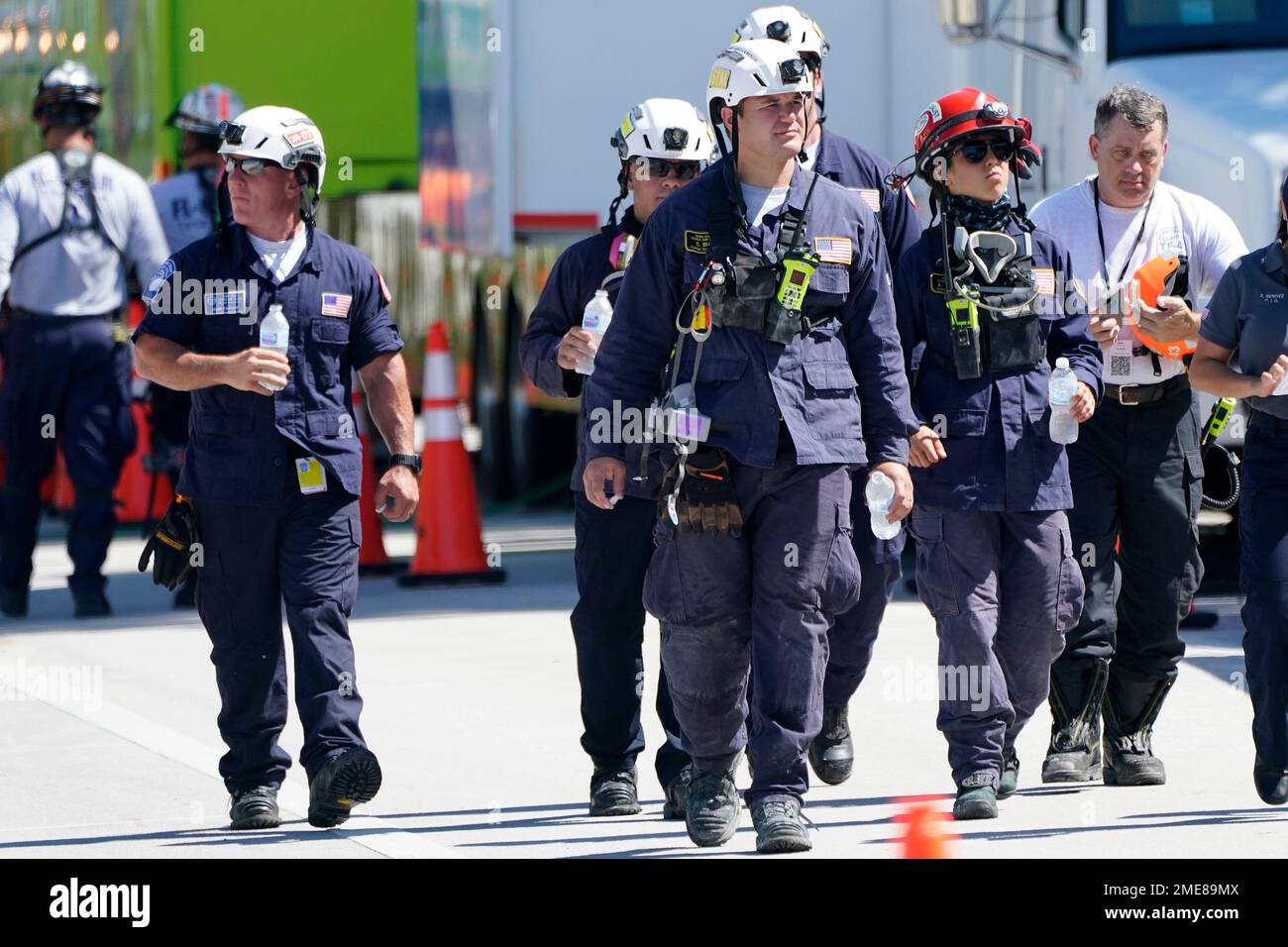 Members of the South Florida Urban Search and Rescue team walk near the ...