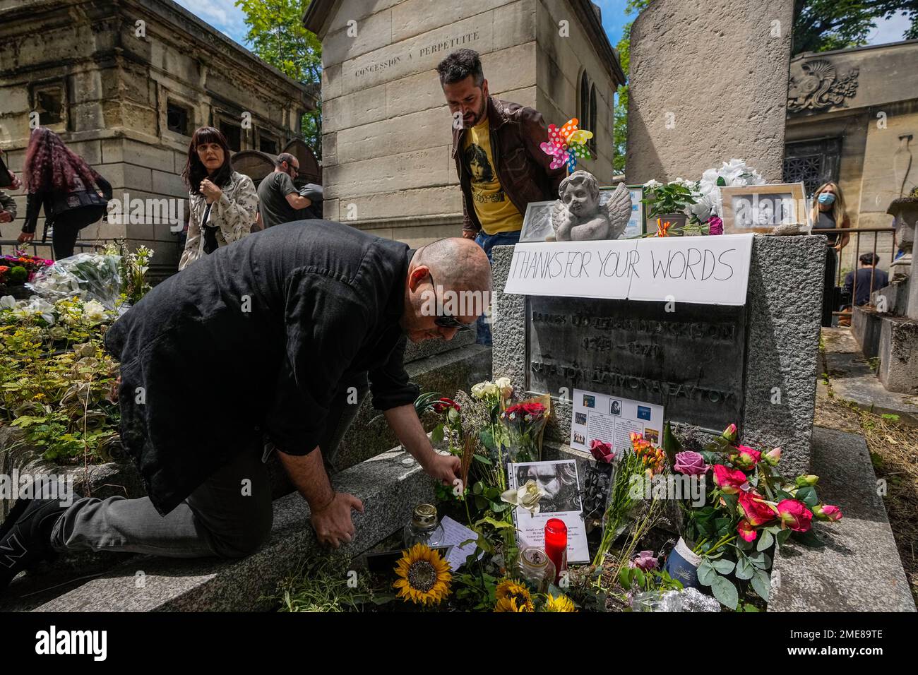 Fans gather at the tomb of rock singer Jim Morrison at the Pere ...