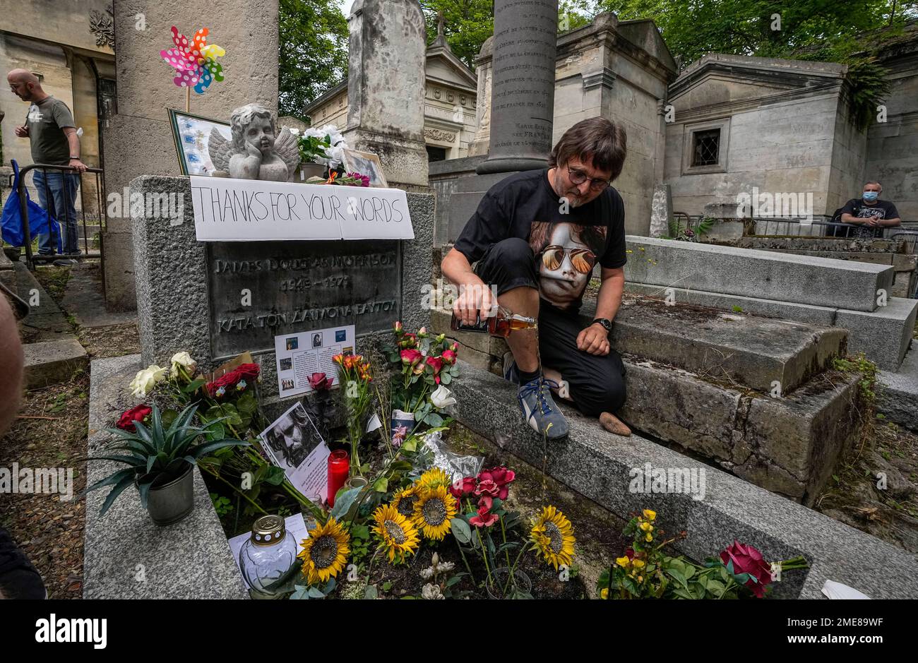 Torsten Marquardt of Germany pours some whiskey on the tomb of rock ...