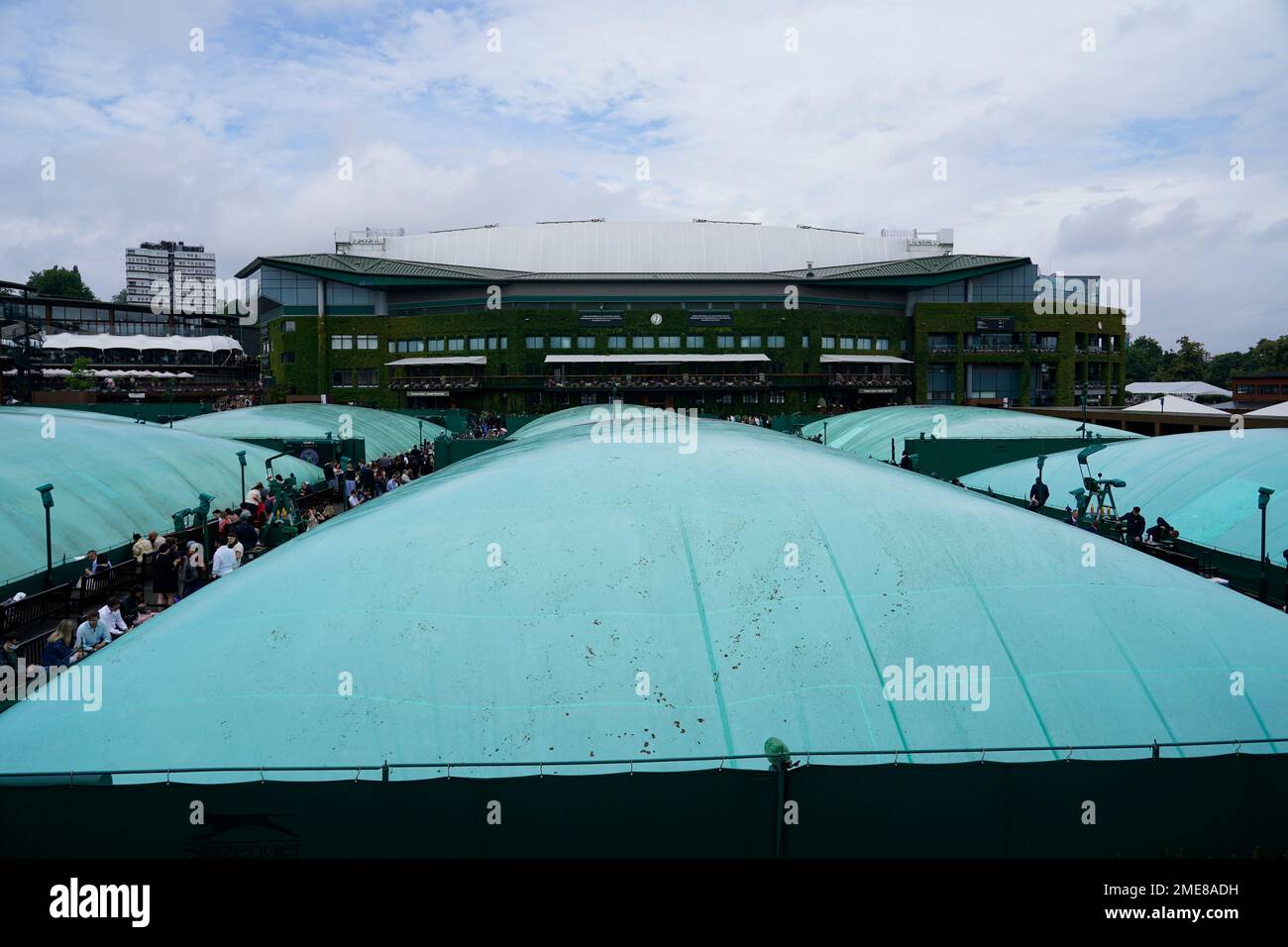 The outside courts are covered during a rain delay on day six of the ...