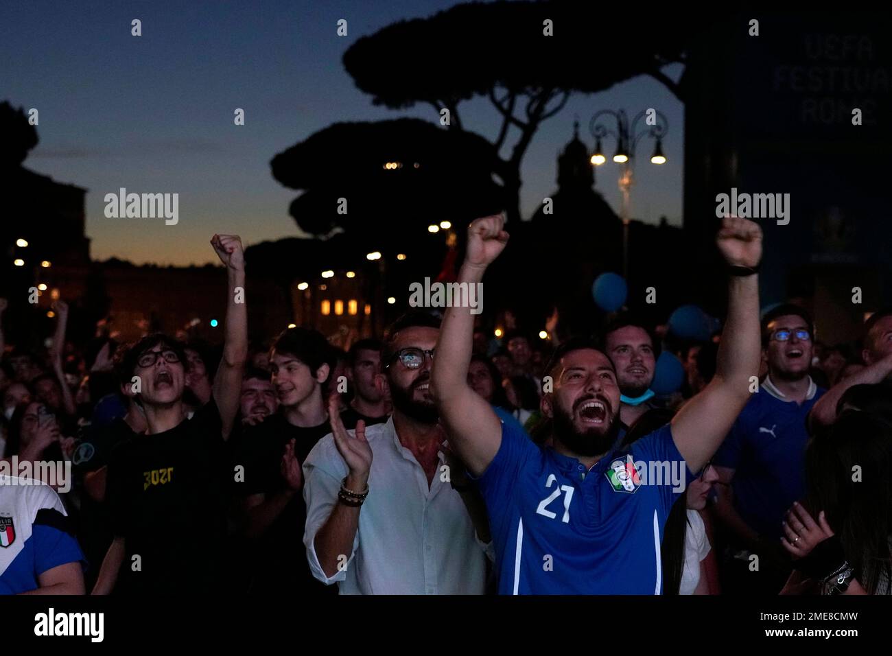 Italy's soccer fans celebrate as they watch on a giant screen the Euro ...