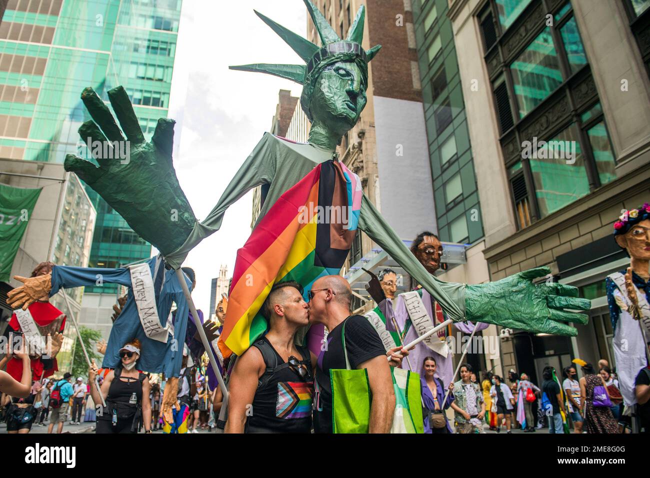 Christopher Williams and his husband Ed Stallsworth kiss while marching ...