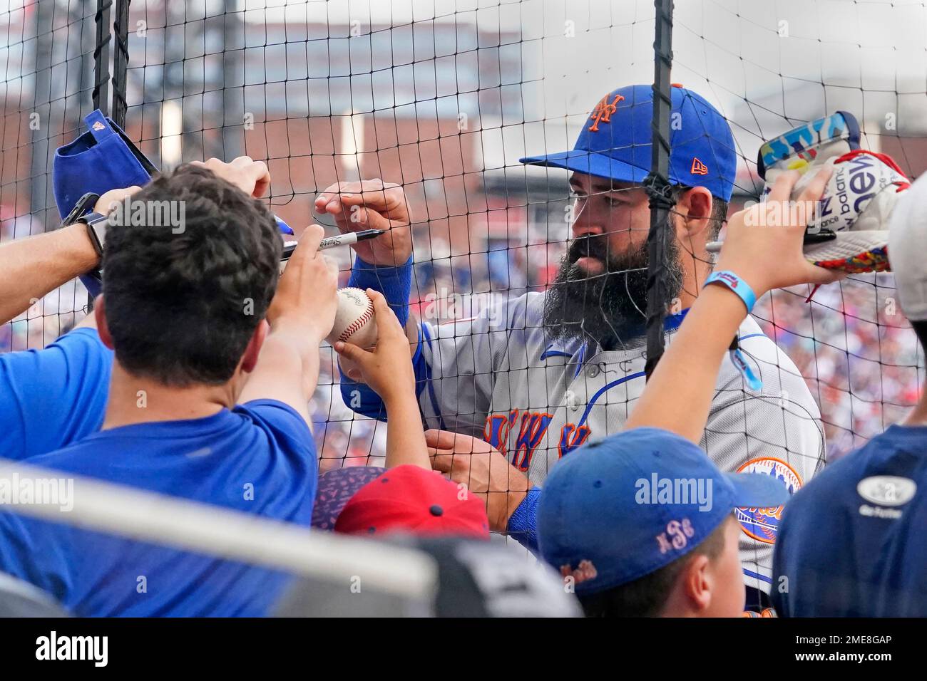 New York Mets' Luis Guillorme signs autographs for fans before the team ...