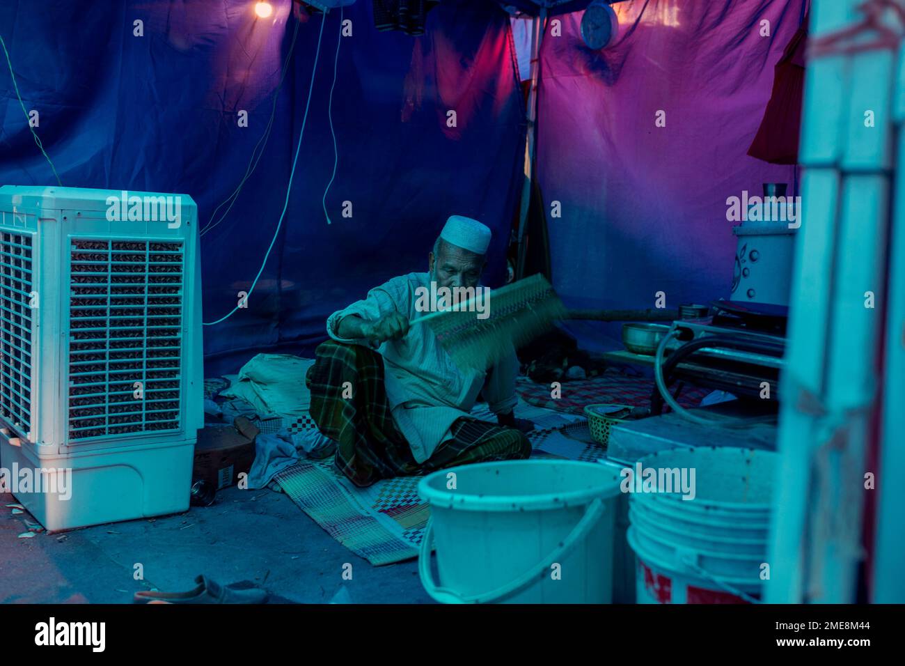An elderly Rohingya refugee man uses a hand fan at a makeshift camp on ...