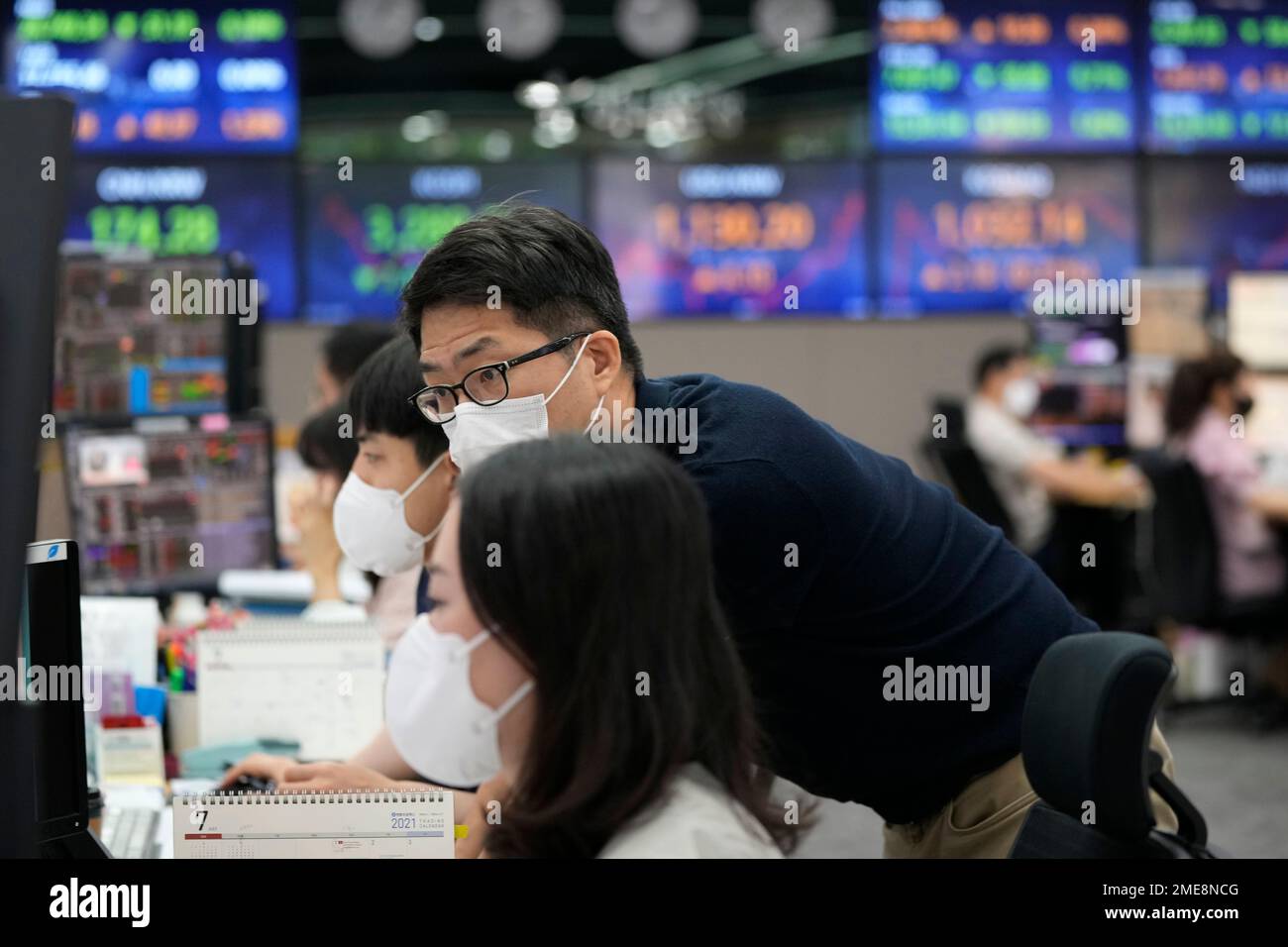 Currency traders watch monitors at the foreign exchange dealing room of ...