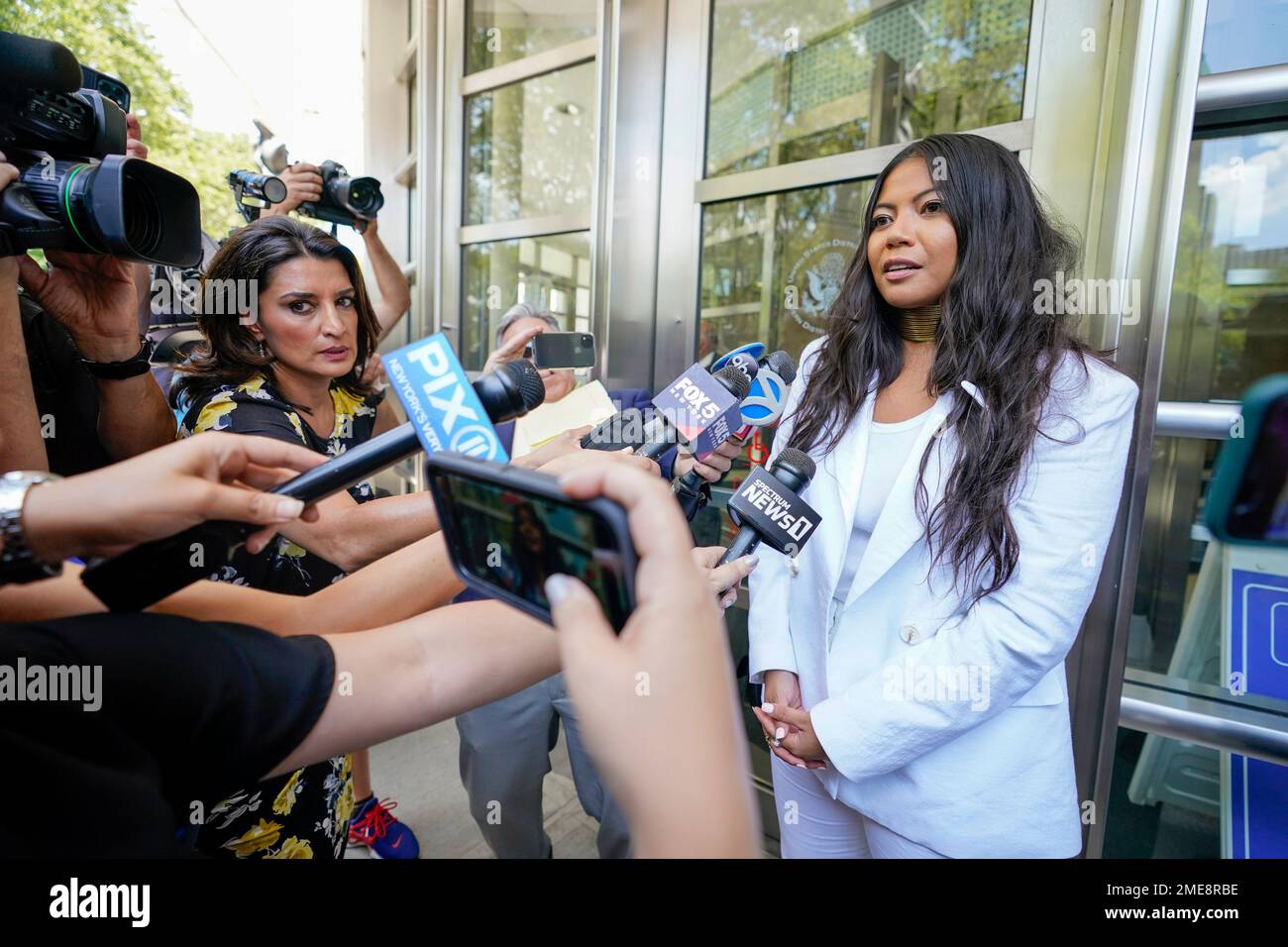 Former NXIVM member Jessica Joan speaks to reporters outside federal ...