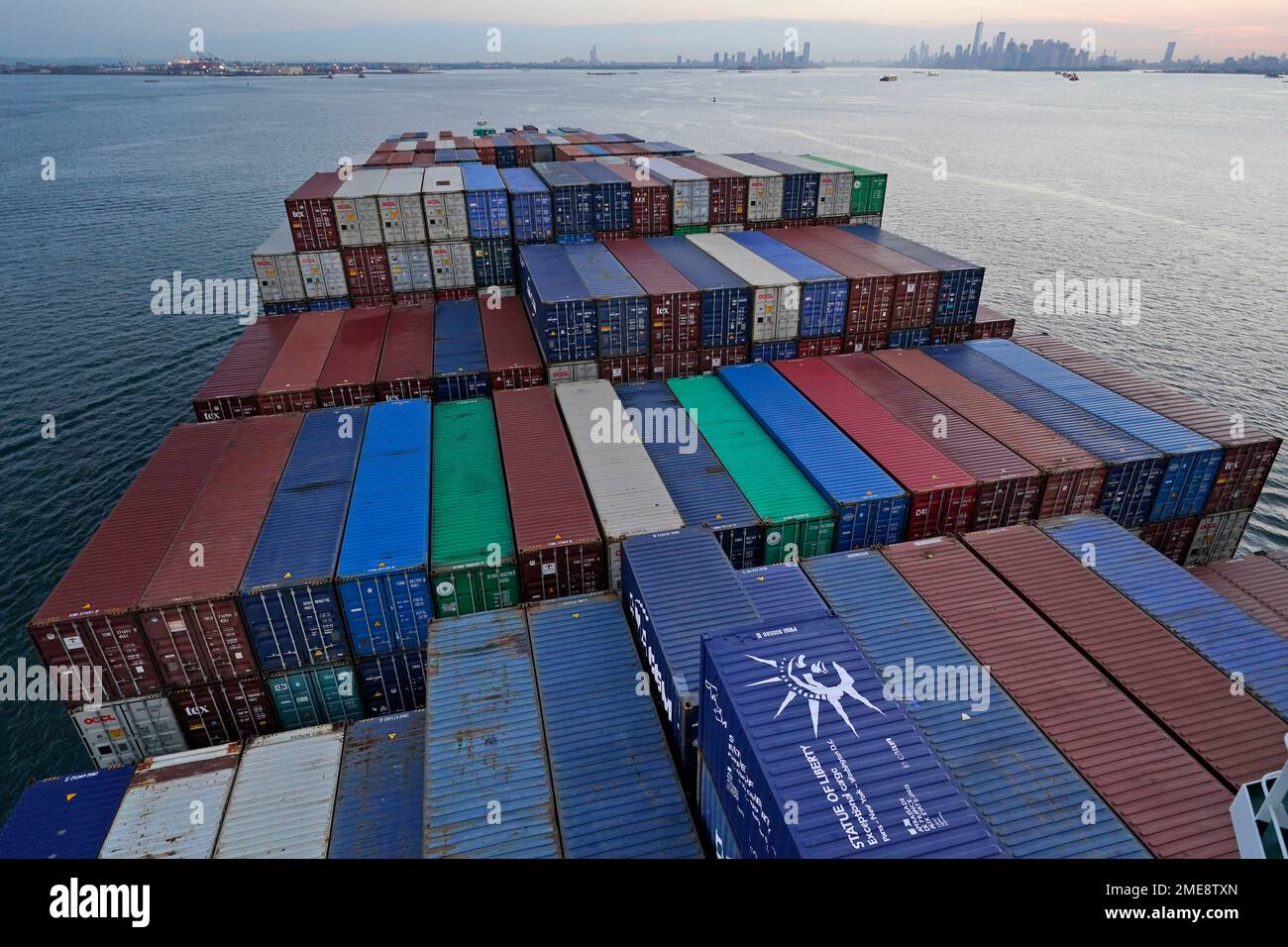 The skyline of New York is visible as a container carrying a replica of ...