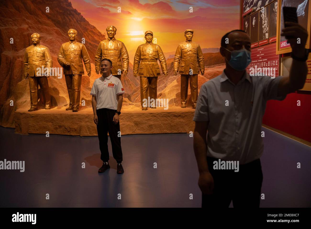 Visitors pose for photos in front of statues of Chinese Leader Mao ...