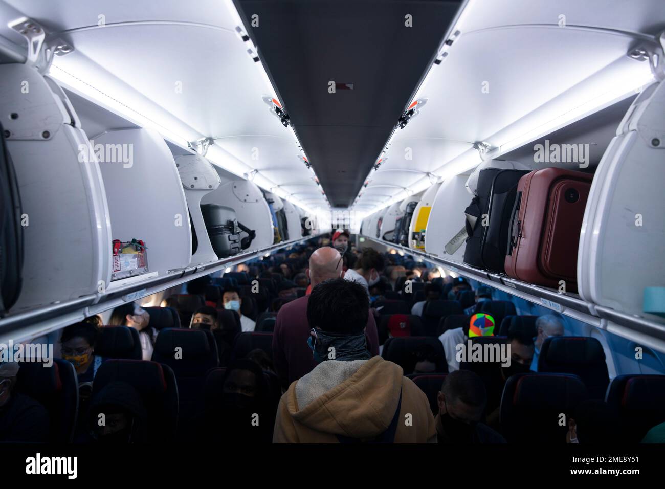 In this June 7, 2021, photo people board an American Airlines flight at ...