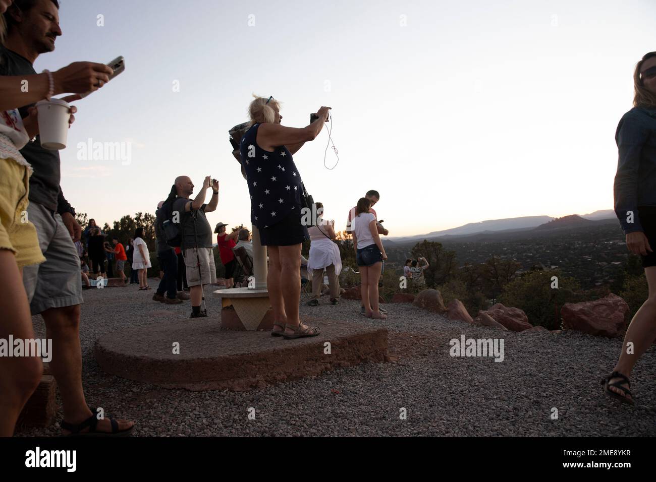 People take photos from the Sedona Airport Scenic Lookout as the sun ...