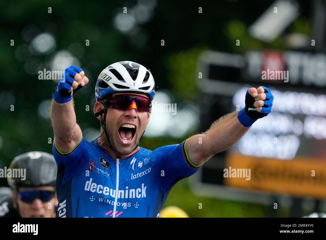 Britain's Mark Cavendish celebrates as he crosses the finish line to ...