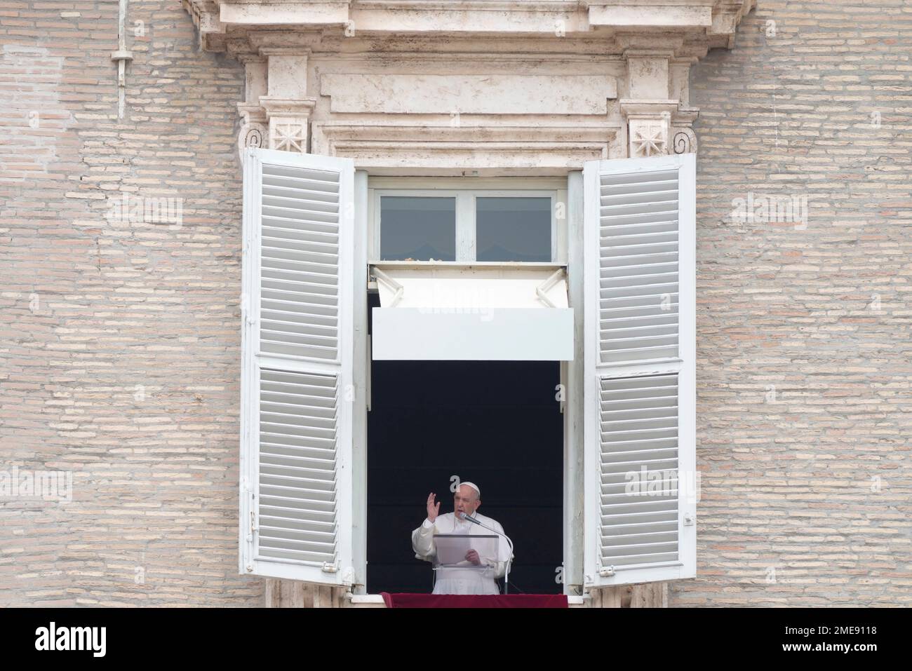 Pope Francis salutes from the window of his studio overlooking St ...