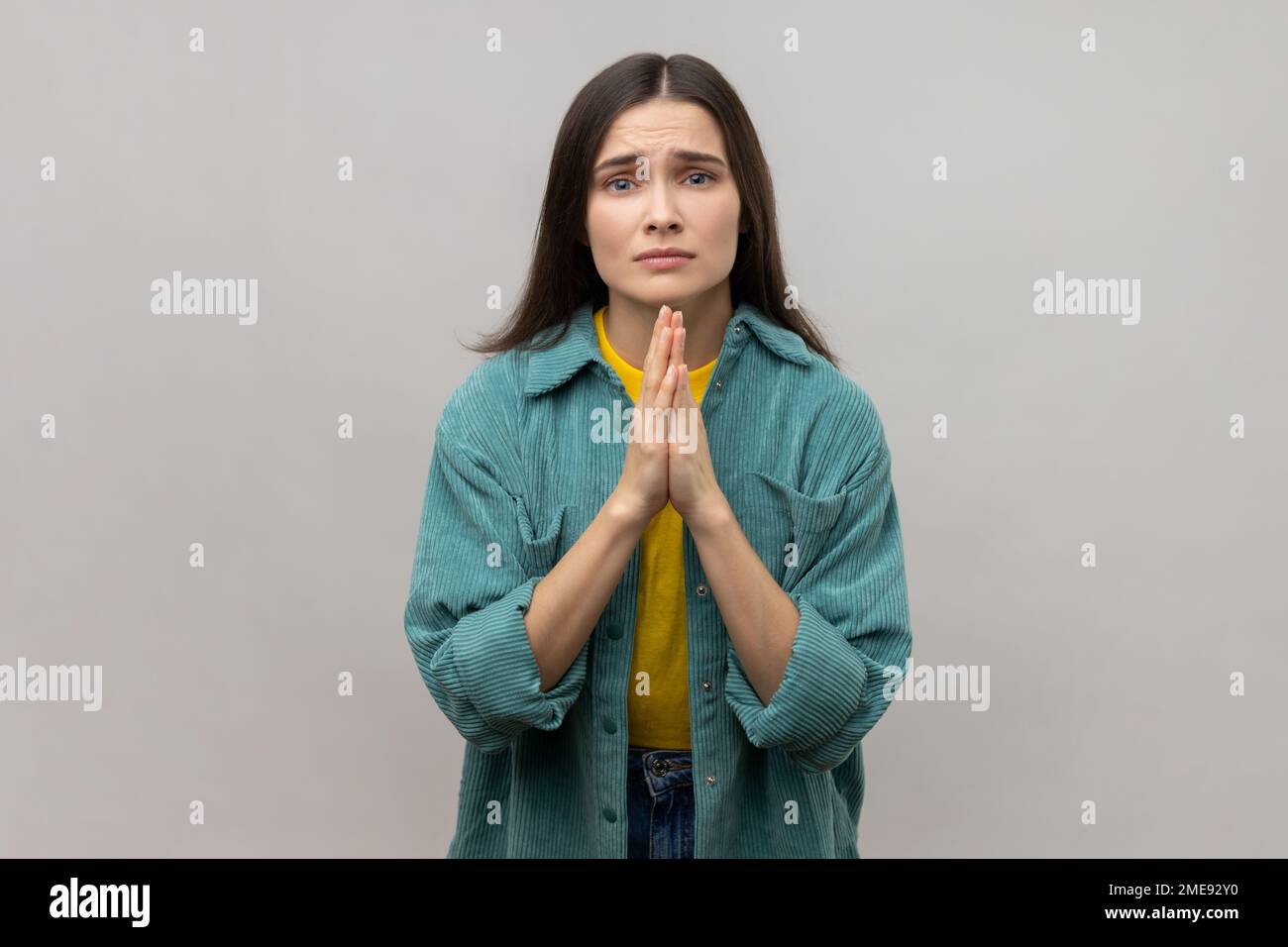 Please, I'm begging. Desperate woman keeping arms in prayer gesture and ...