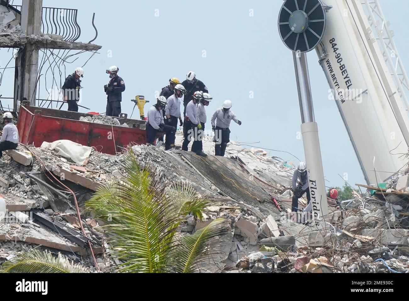 Rescue workers cut into a large slab of concrete at the Champlain ...
