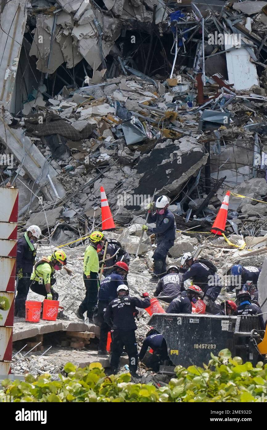 Rescue workers dig in the rubble at the Champlain Towers South Condo ...