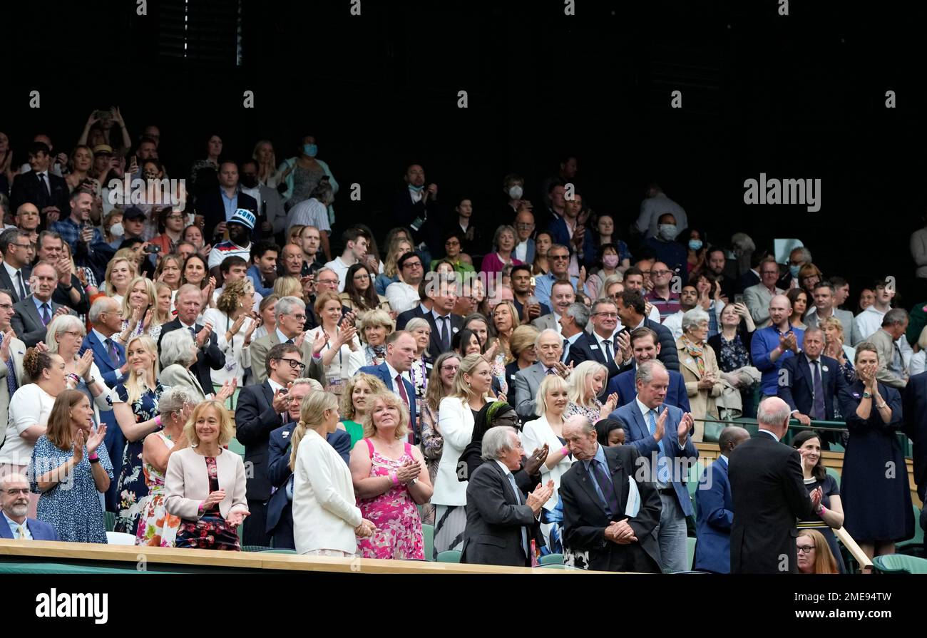 People in Centre Court stand and applaud invited guests representing ...