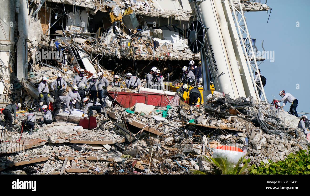 Workers search the rubble at the Champlain Towers South Condo, Monday ...