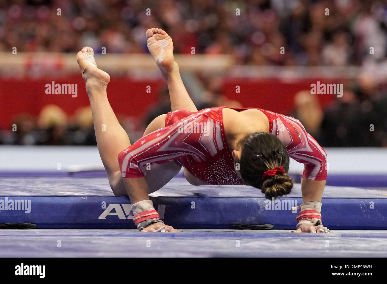 Kayla DiCello falls while competing on the uneven bars during the women ...