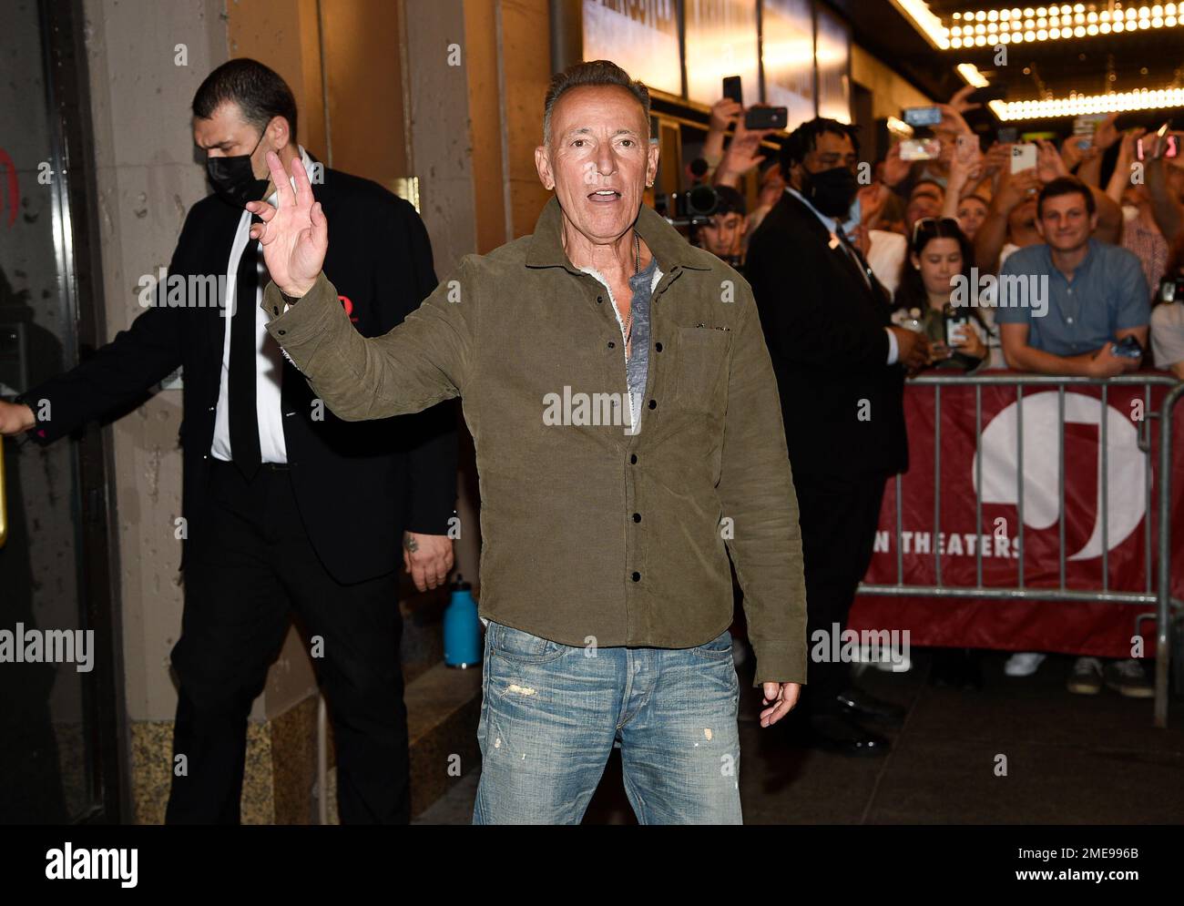 Singer-songwriter Bruce Springsteen exits out the stage door after the ...