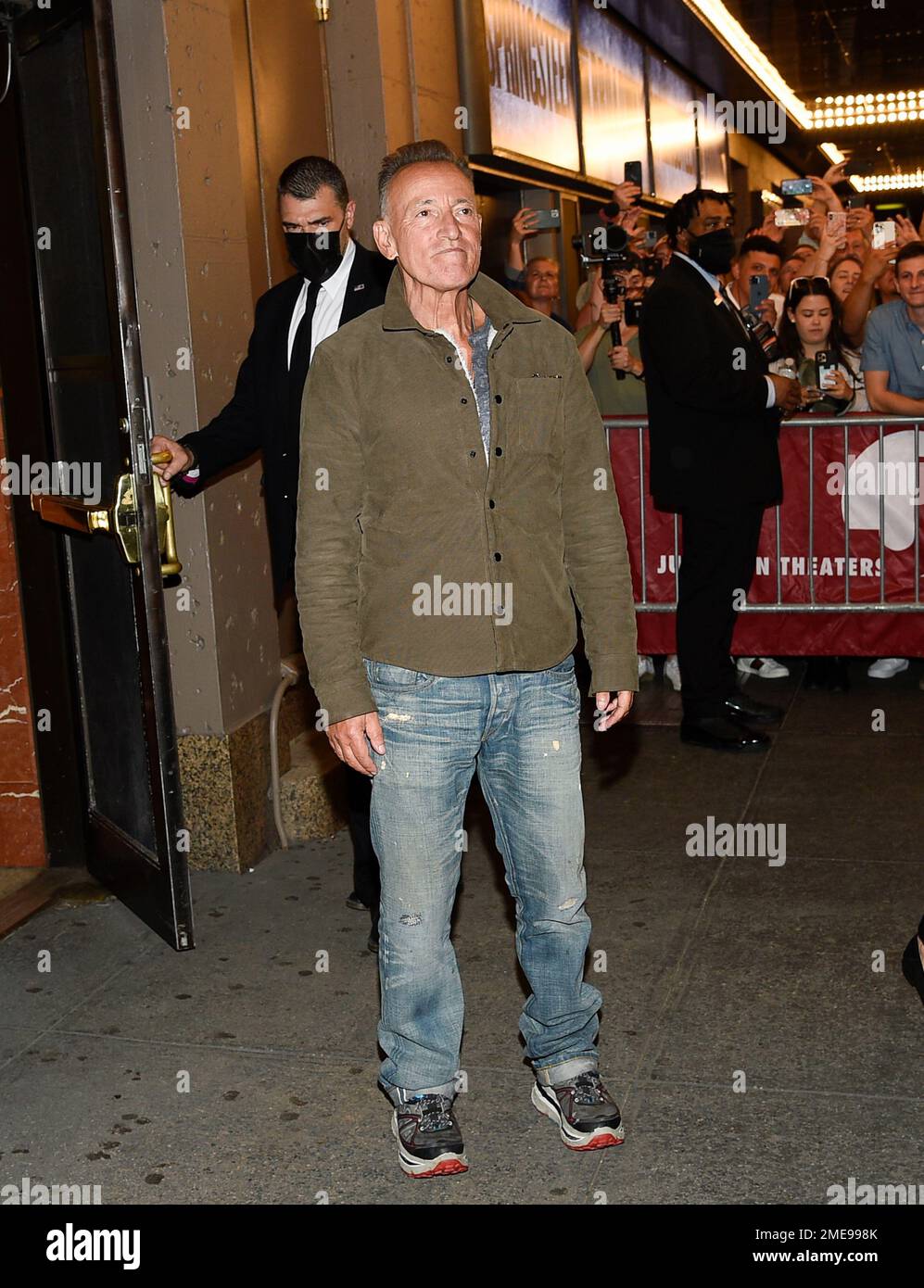 Singer-songwriter Bruce Springsteen exits out the stage door after the ...