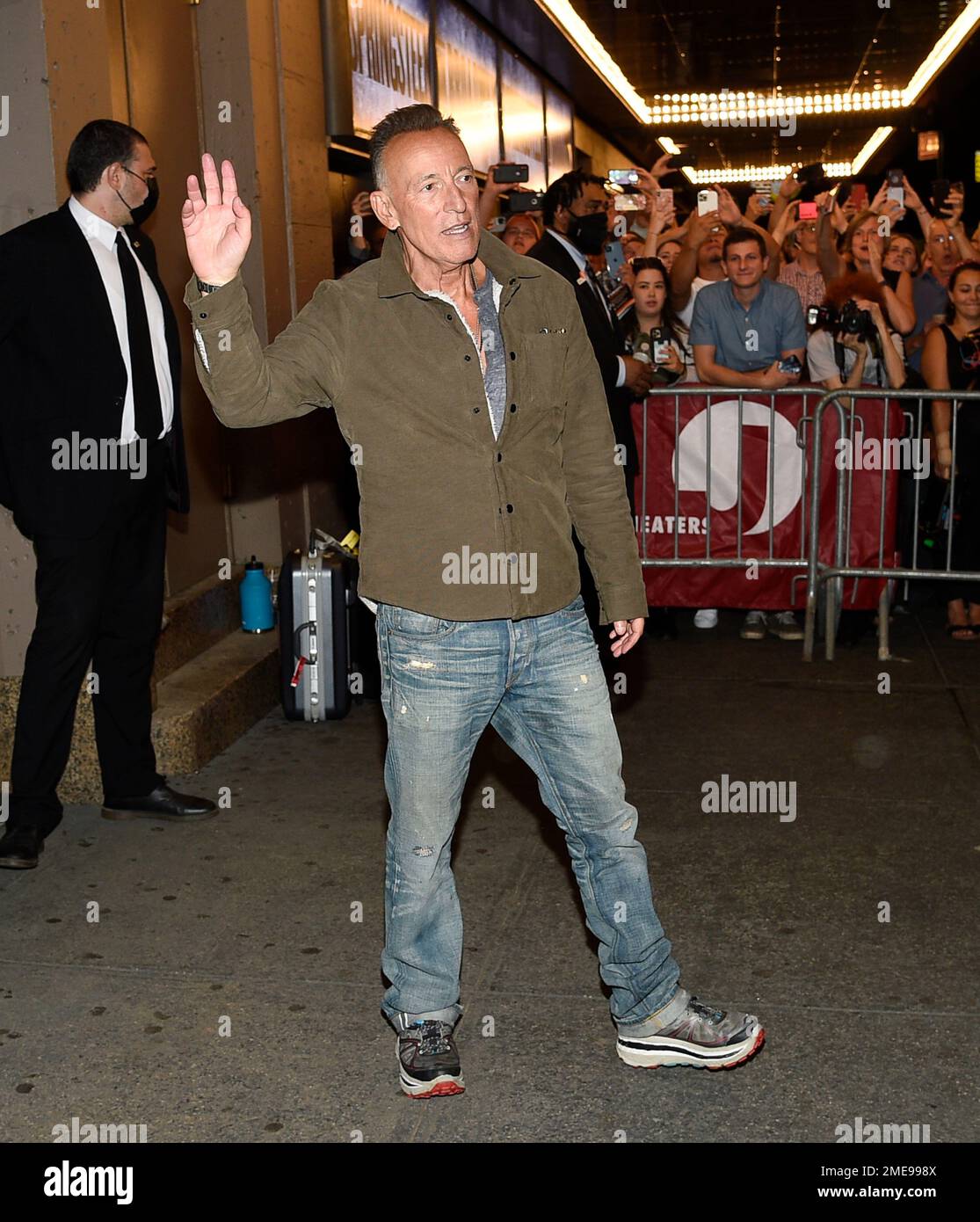 Singer-songwriter Bruce Springsteen exits out the stage door after the ...