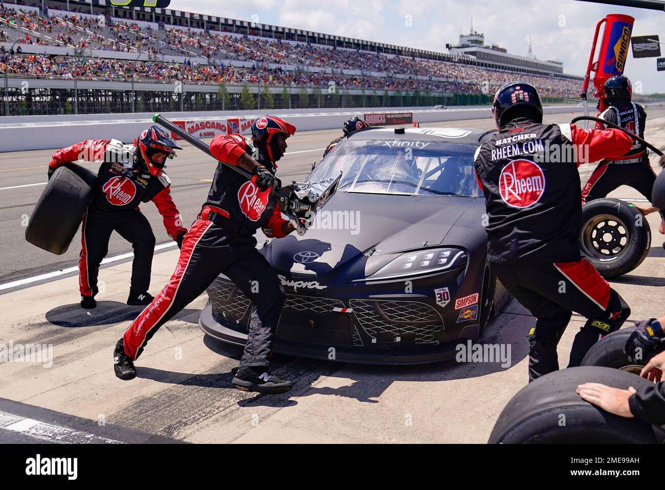 The pit crew for Ty Gibbs (54) service the car at a stop during a ...