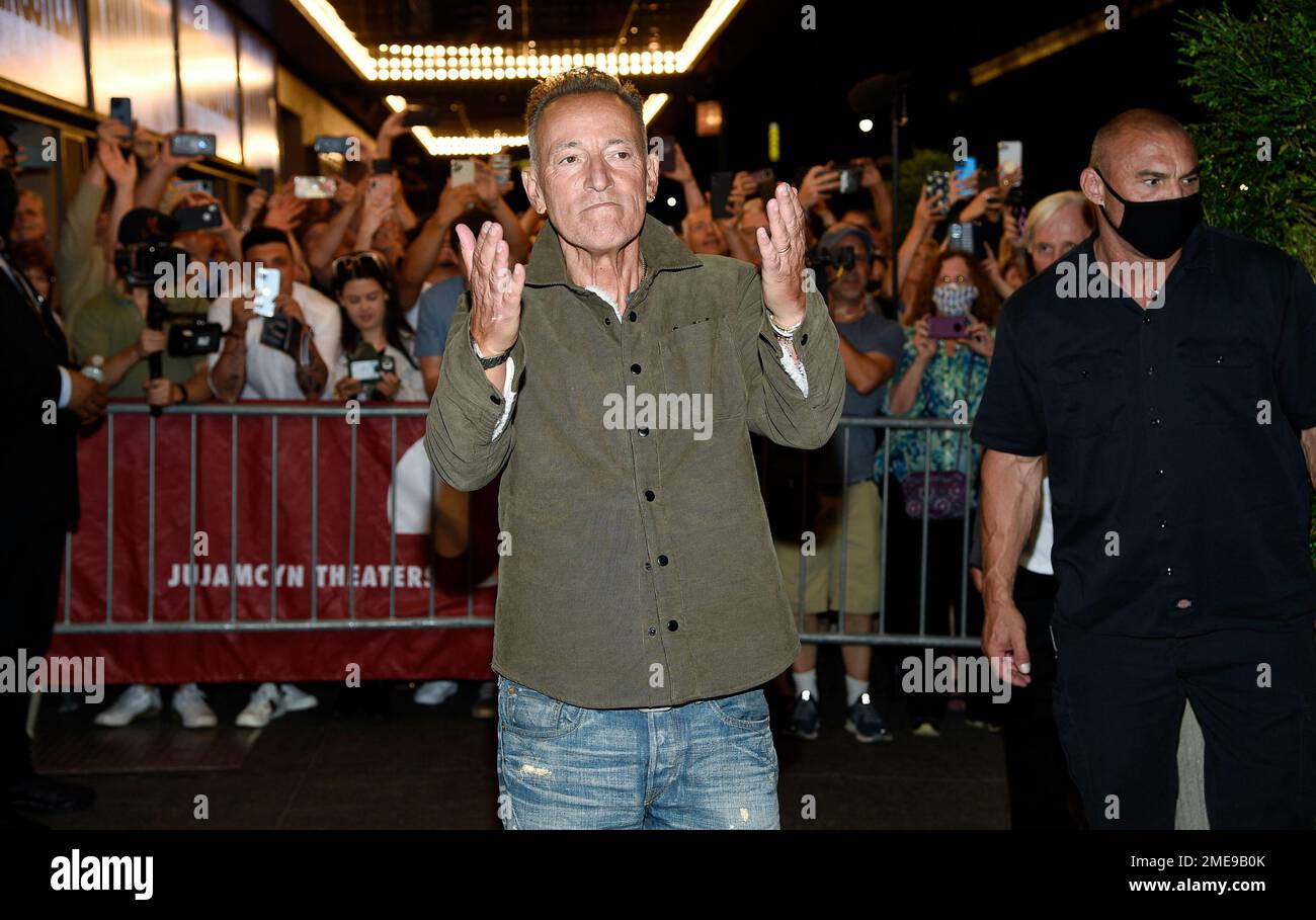 Singer-songwriter Bruce Springsteen exits out the stage door after the ...
