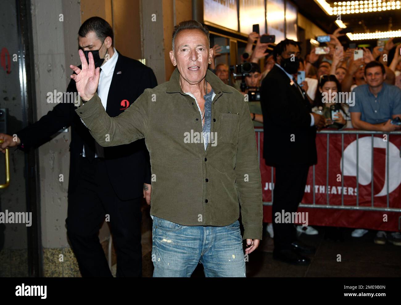 Singer-songwriter Bruce Springsteen exits out the stage door after the ...