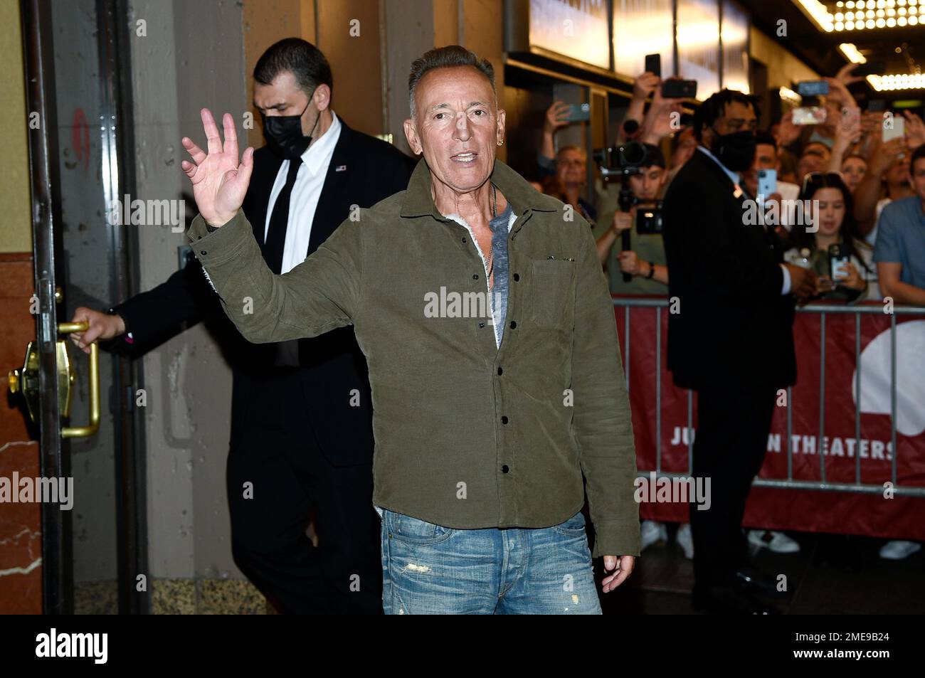 Singer-songwriter Bruce Springsteen exits out the stage door after the ...