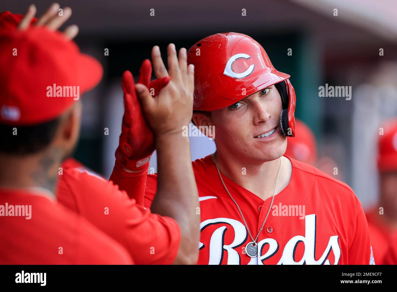 Cincinnati Reds' Tyler Stephenson high-fives teammates ini the dugout ...