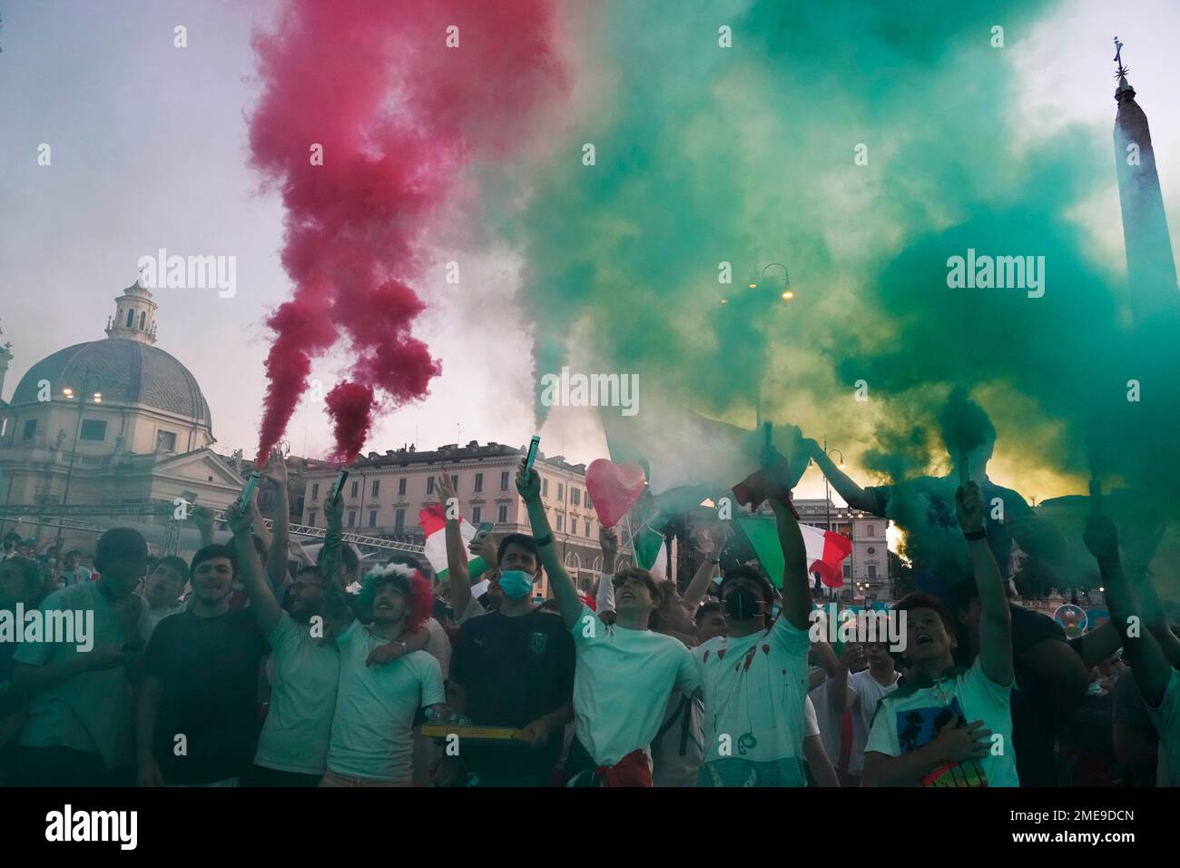 Soccer fans light flares as they watch on a giant screen the Euro 2020 ...