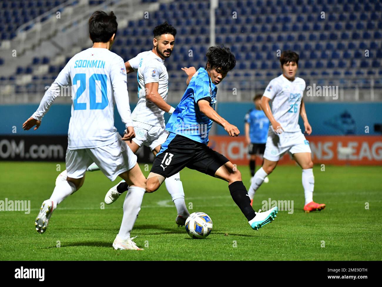Kawasaki Frontale's Miki Yamane, centre, and Daegu's Hwang Soonmin, left, in action during their ...