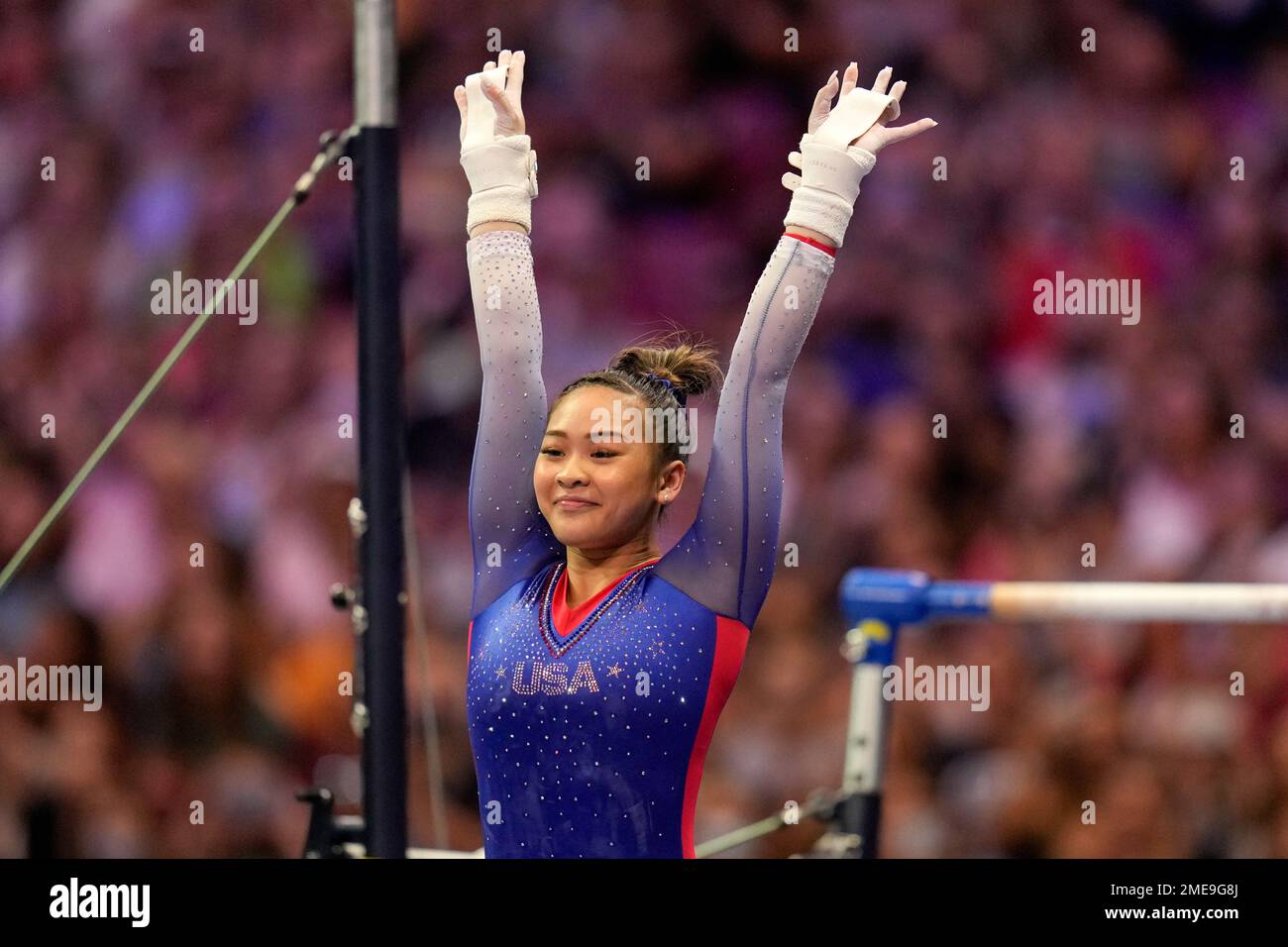 Suni Lee reacts to her performance on the uneven bars during the women ...