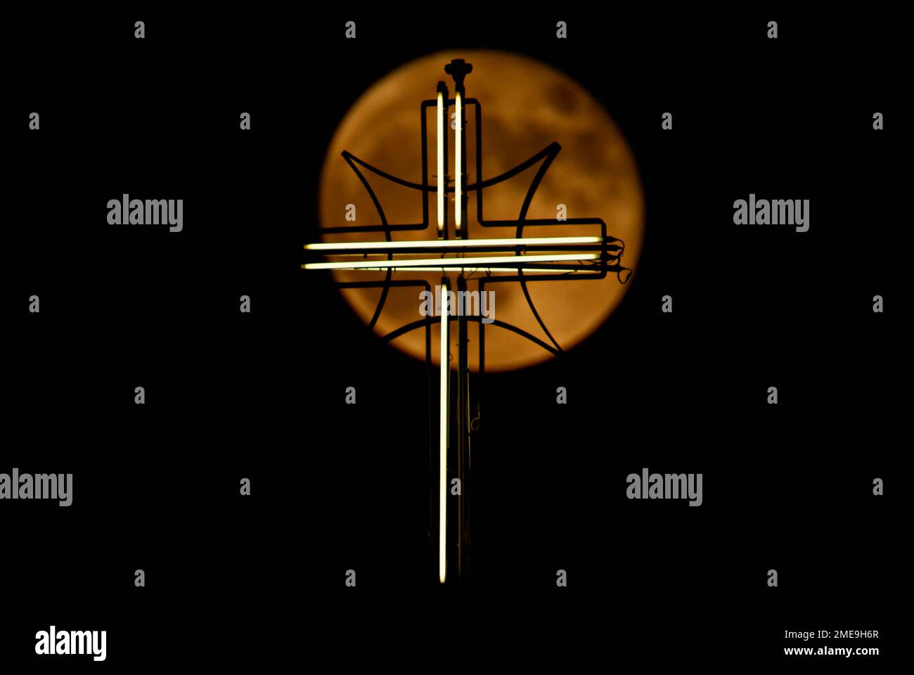 The moon rises over the cross of St. Joseph Church in Baghdad, Iraq ...