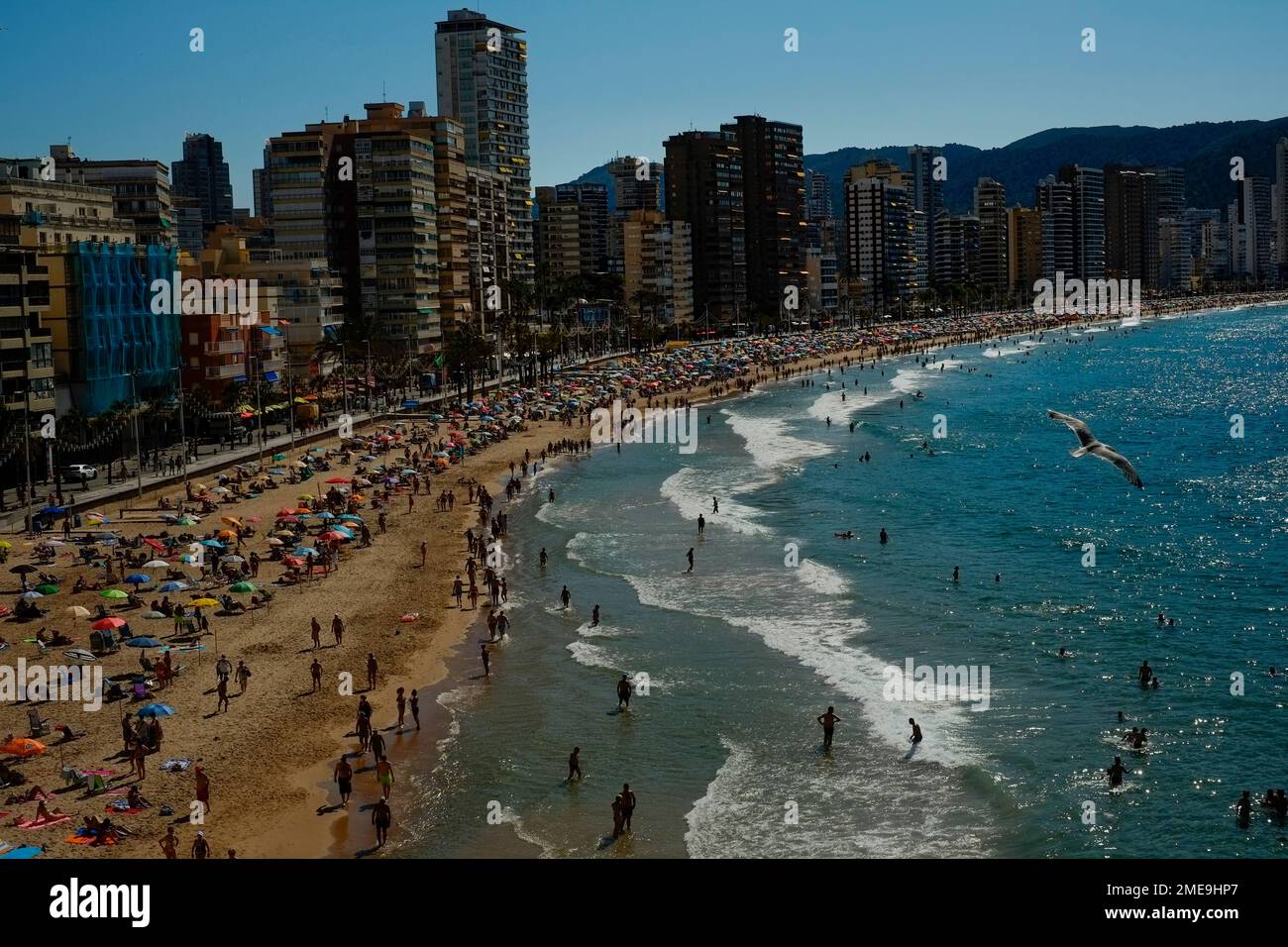People enjoy a summer's day along the beach in Benidorm, south-east ...