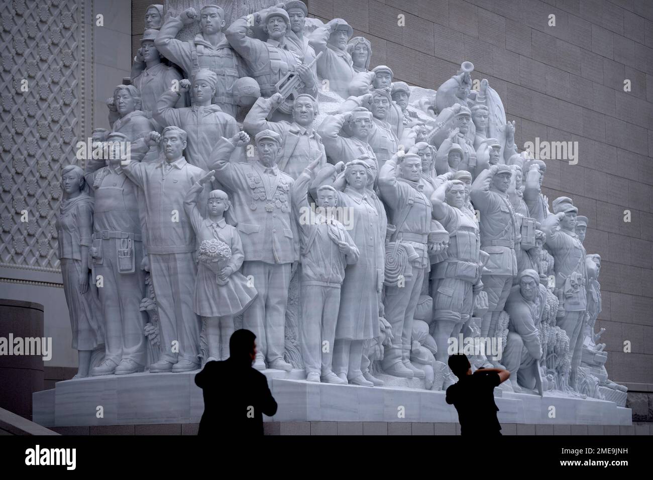 People take photos of a sculpture outside of the newly-completed Museum ...