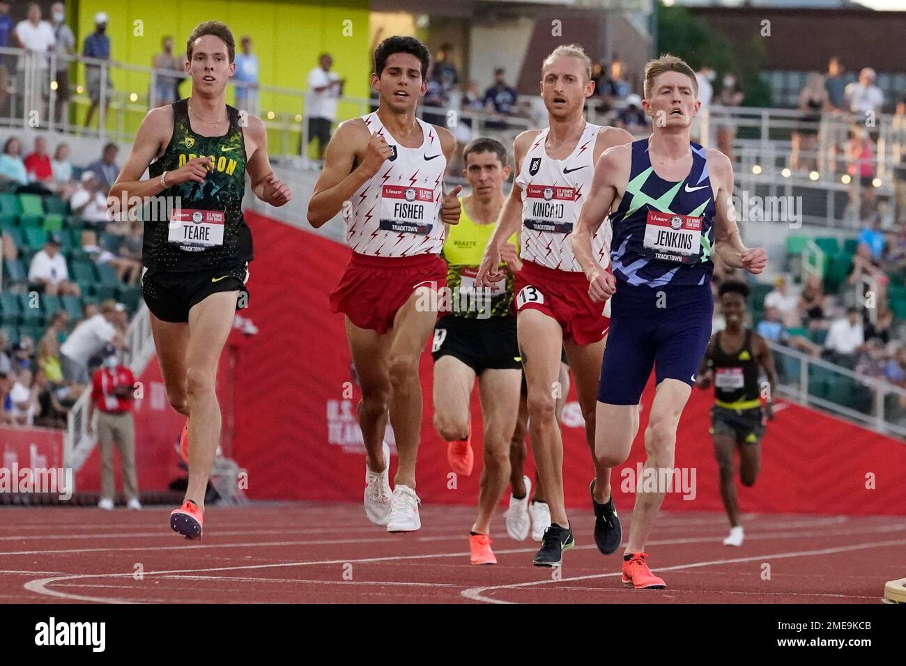 Eric Jenkins, right, wins the first heat of men's 5000-meter run at the ...