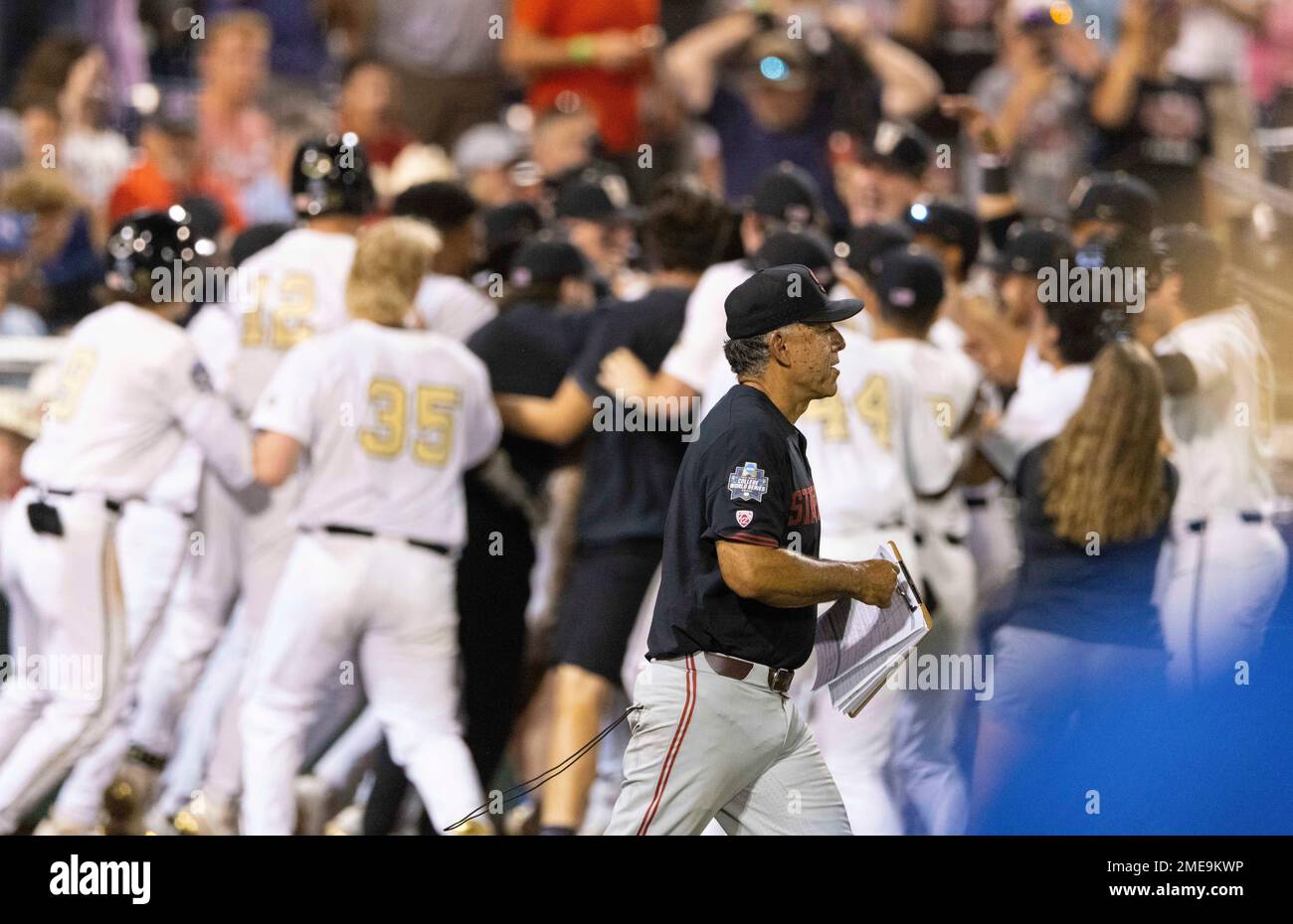 Stanford head coach David Esquer walks by as Vanderbilt players ...