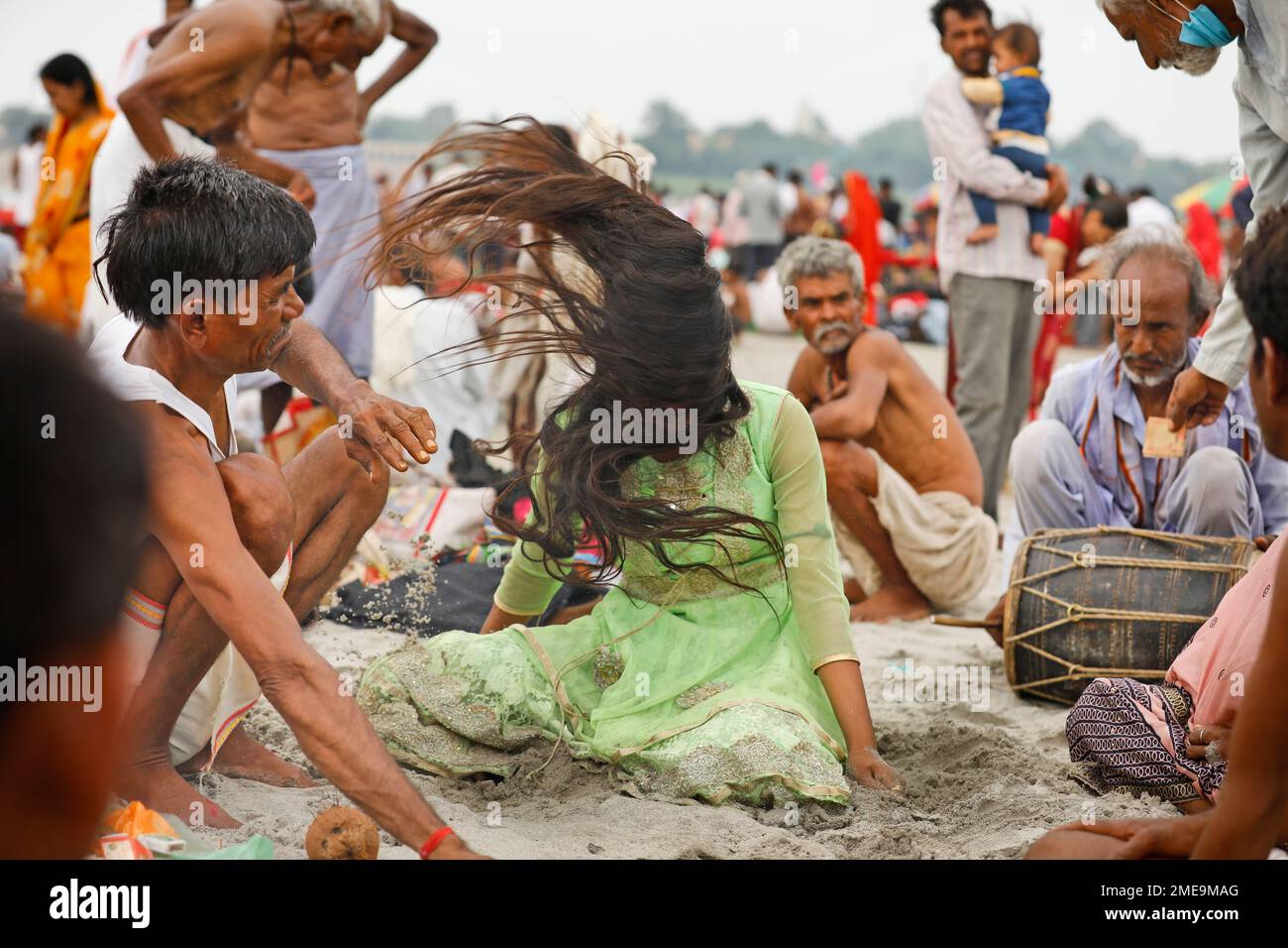 A priest performs exorcism on a Hindu devotee on the banks of the ...