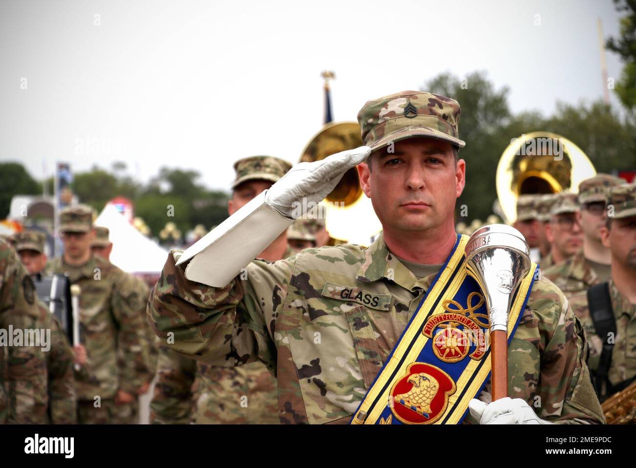 Staff Sgt. Jason Glass, a musician with the 34th Army Band, salutes ...