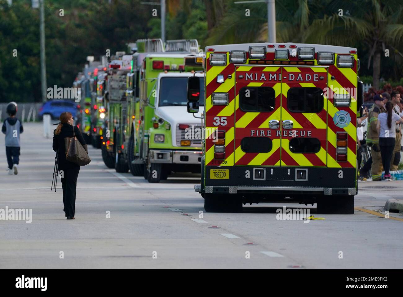 A line of emergency vehicles line the streets near the site of a ...